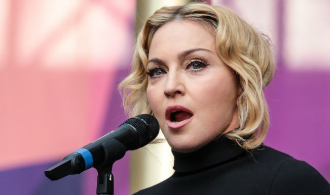Madonna cries onstage as she pays tribute to Paris victims | India.com