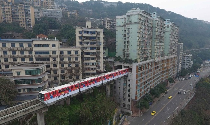 Train arrives to pick passengers from this building in China’s ...